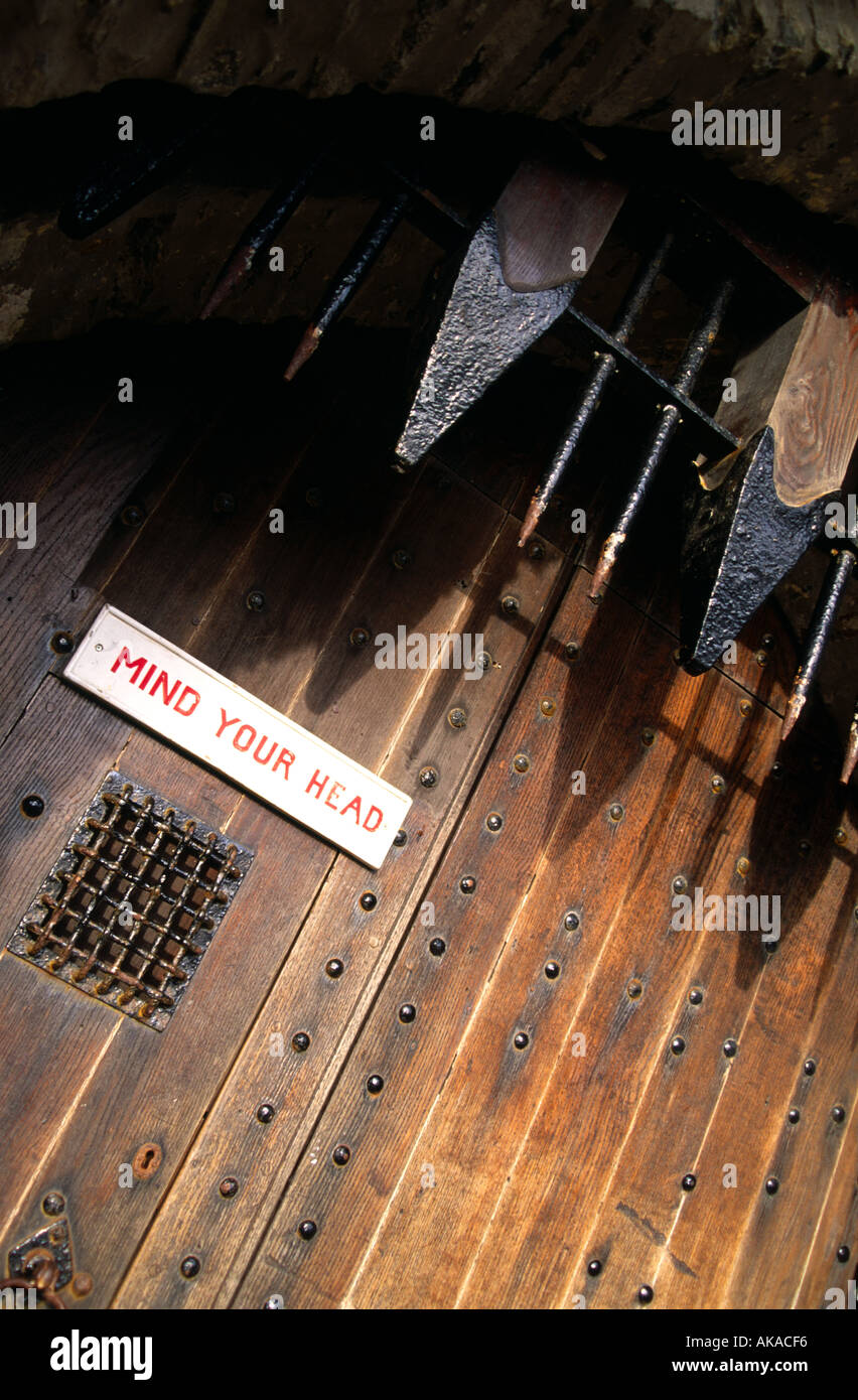 Mind Your Head Sign on Heavy Wooden door below portcullis Stock Photo ...