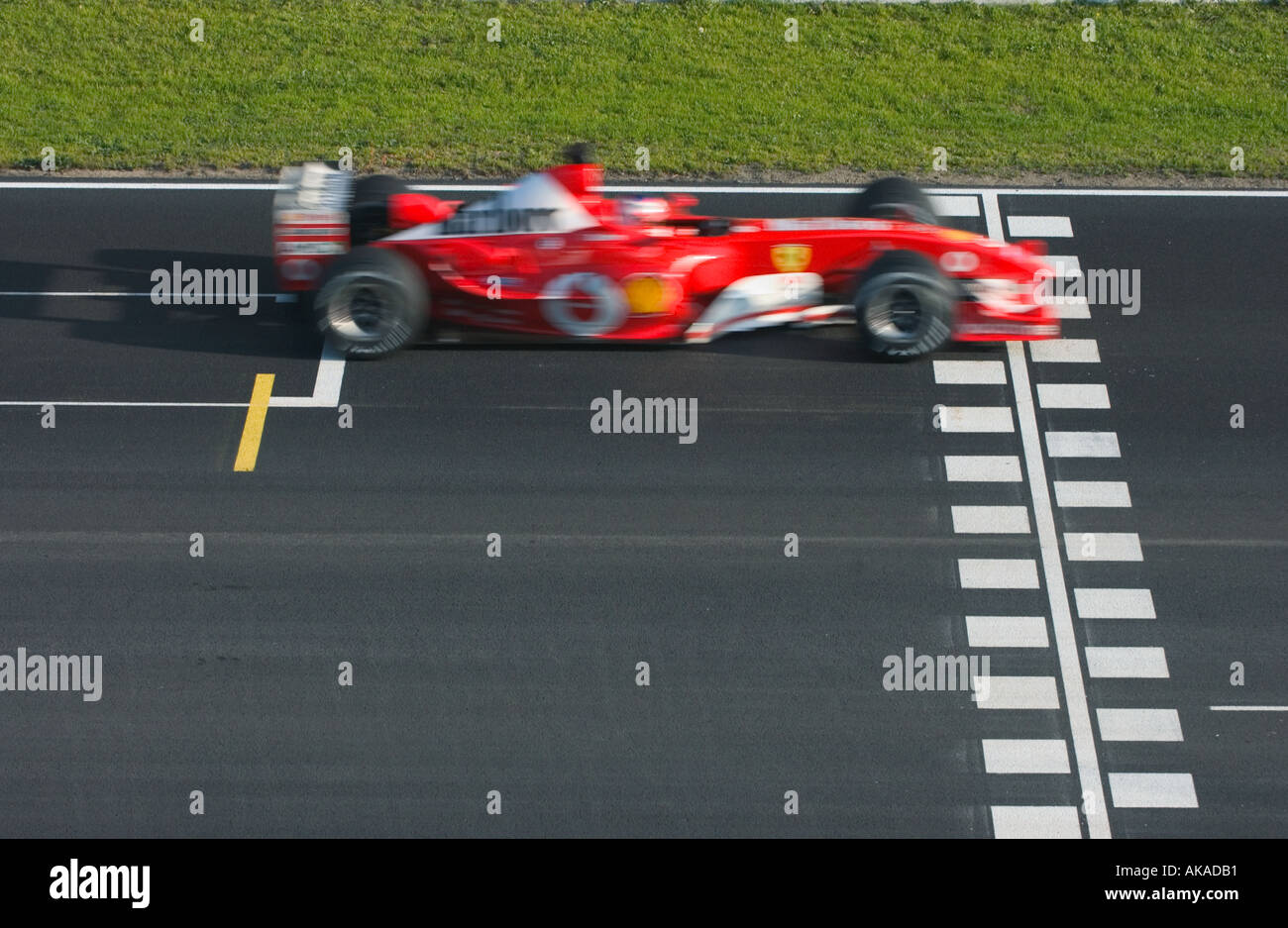 Rubens Barrichello crossing the finish line in the Ferrari Formula One racecar in 2004 Stock ...