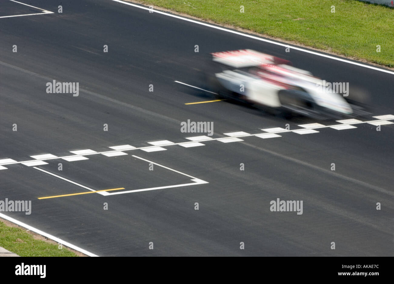 Jenson Button crossing the finish line int he BAR Honda racecar in 2004 ...