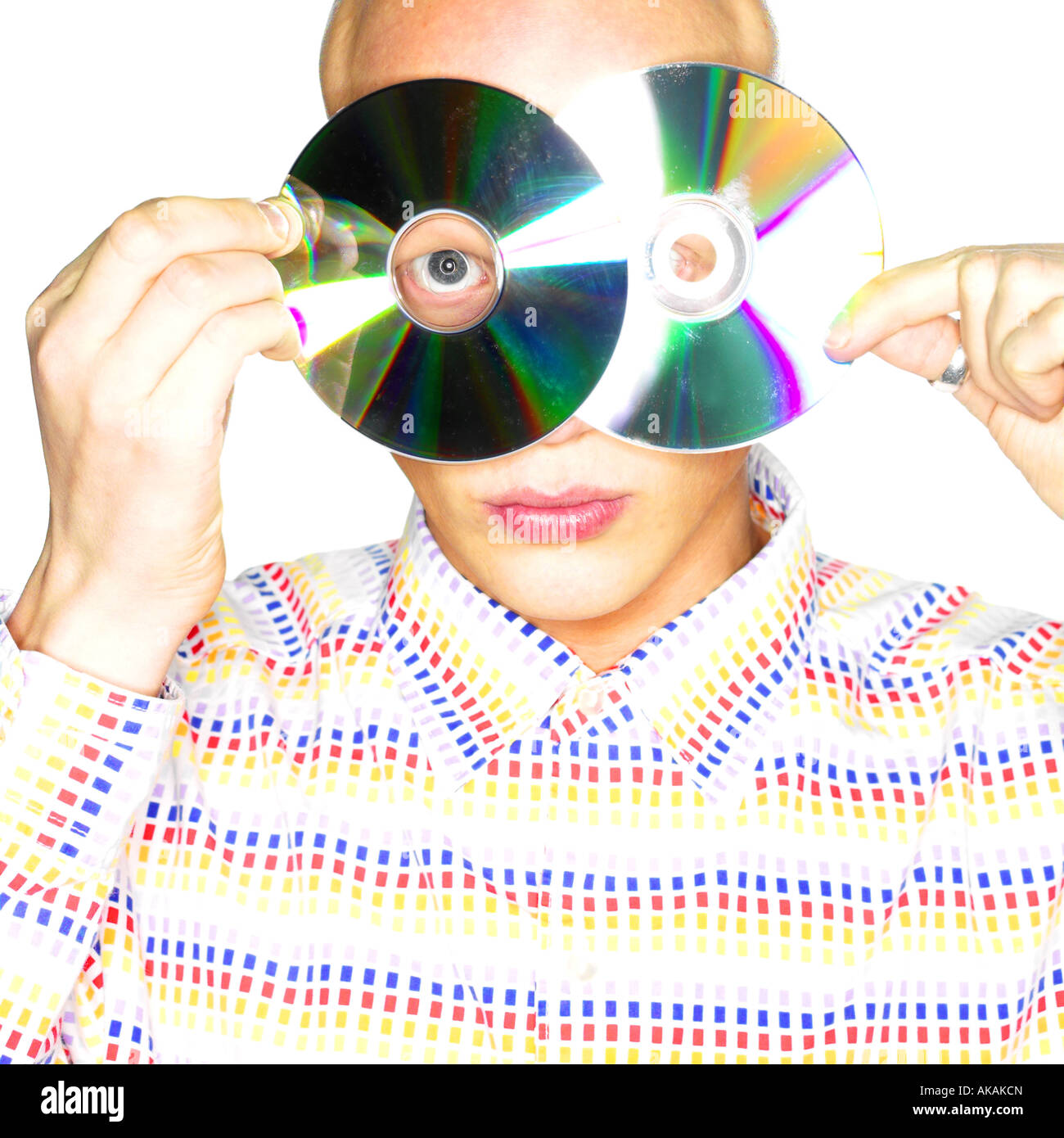 white adult male holding two compact discs cds over eyes wearing ...