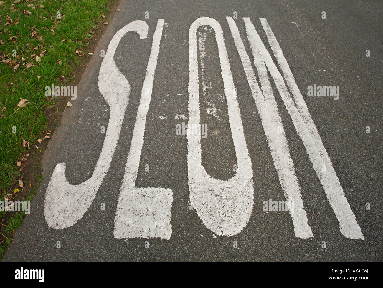 Warning "SLOW" painted onto the road Stock Photo - Alamy