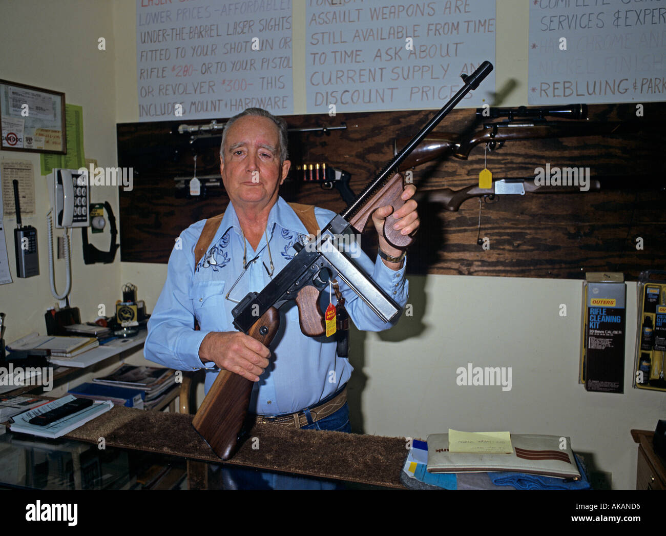 Salesman with large weapon in a gun shop in Florida USA Stock Photo - Alamy