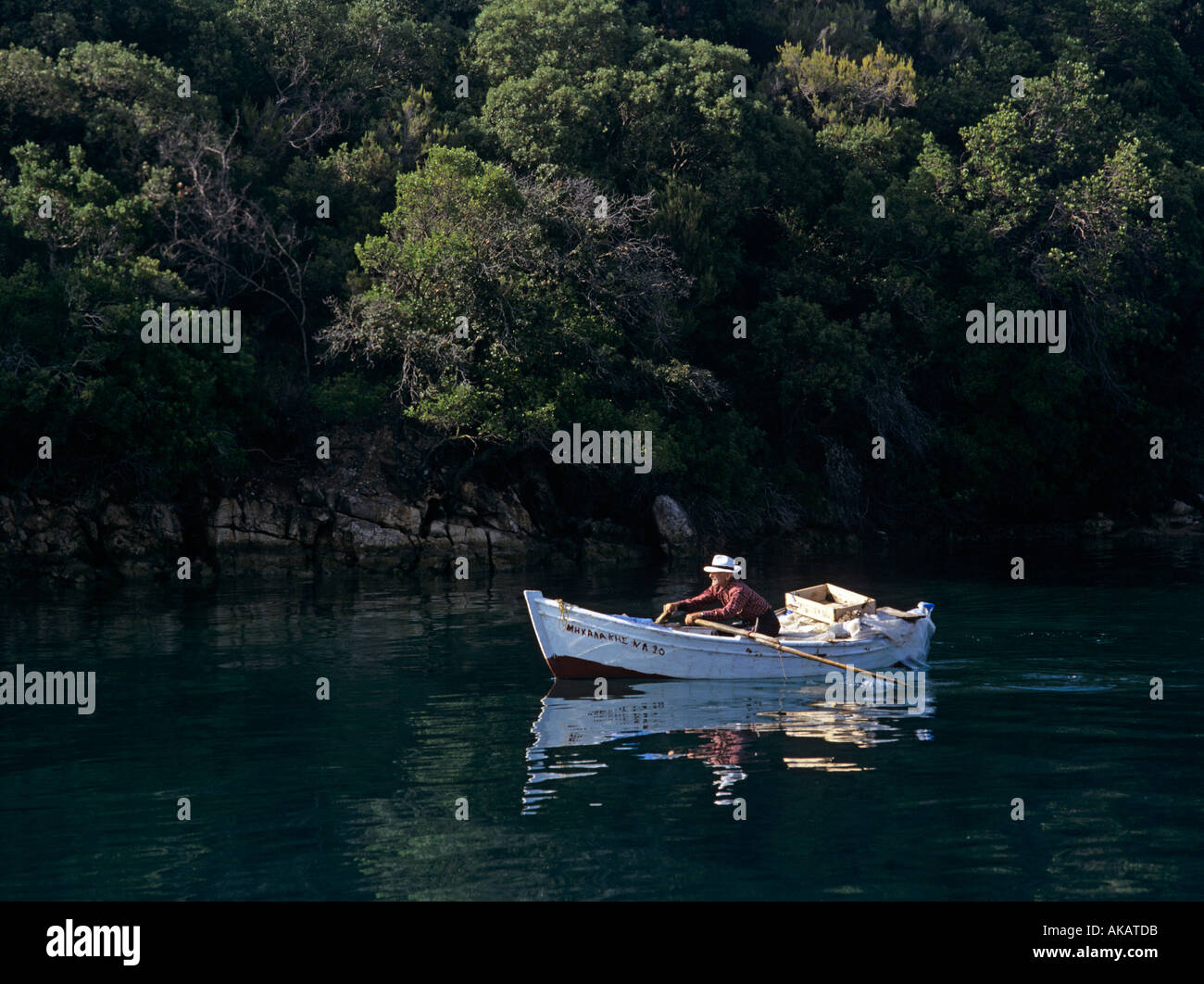 Old greek man rowing fishing boat in Greece Europe Stock Photo - Alamy