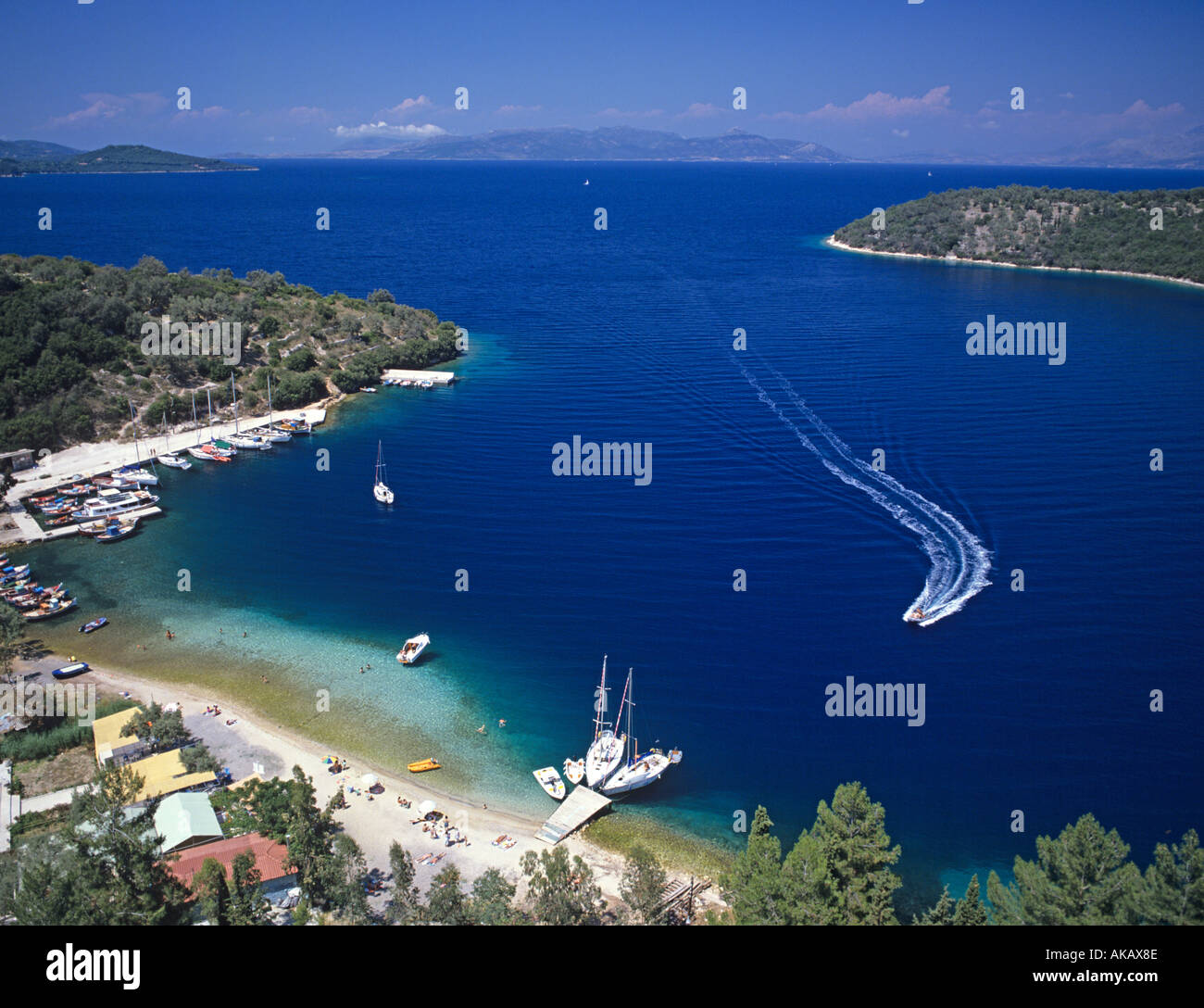View of large blue bay with yachts moored around small jetty and a ...