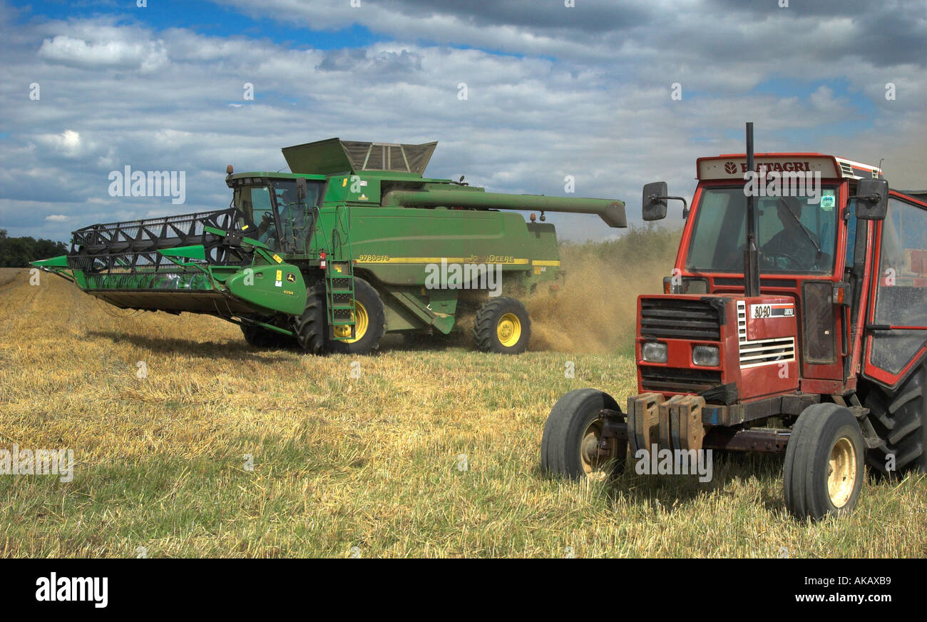 Combine harvester and tractor Stock Photo - Alamy