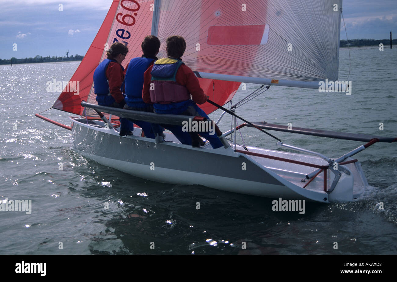 Three sailors sailing a Breeze 6 0 sailboat leaning out Stock Photo - Alamy