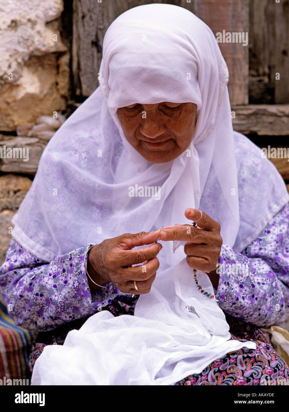 Older Turkish woman in white veil crocheting Turkey Stock Photo - Alamy