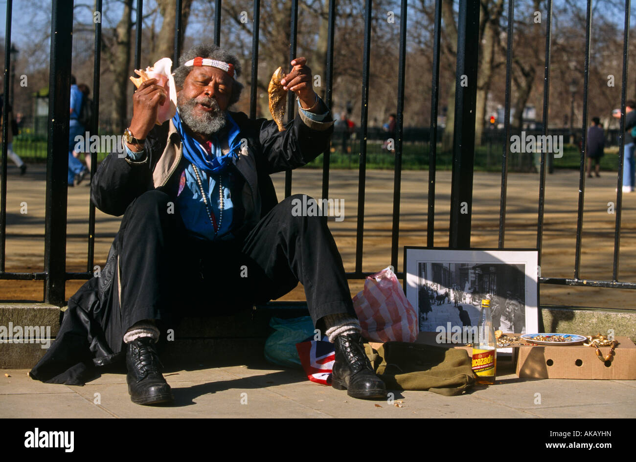 Tramp on street sells his wares Stock Photo - Alamy