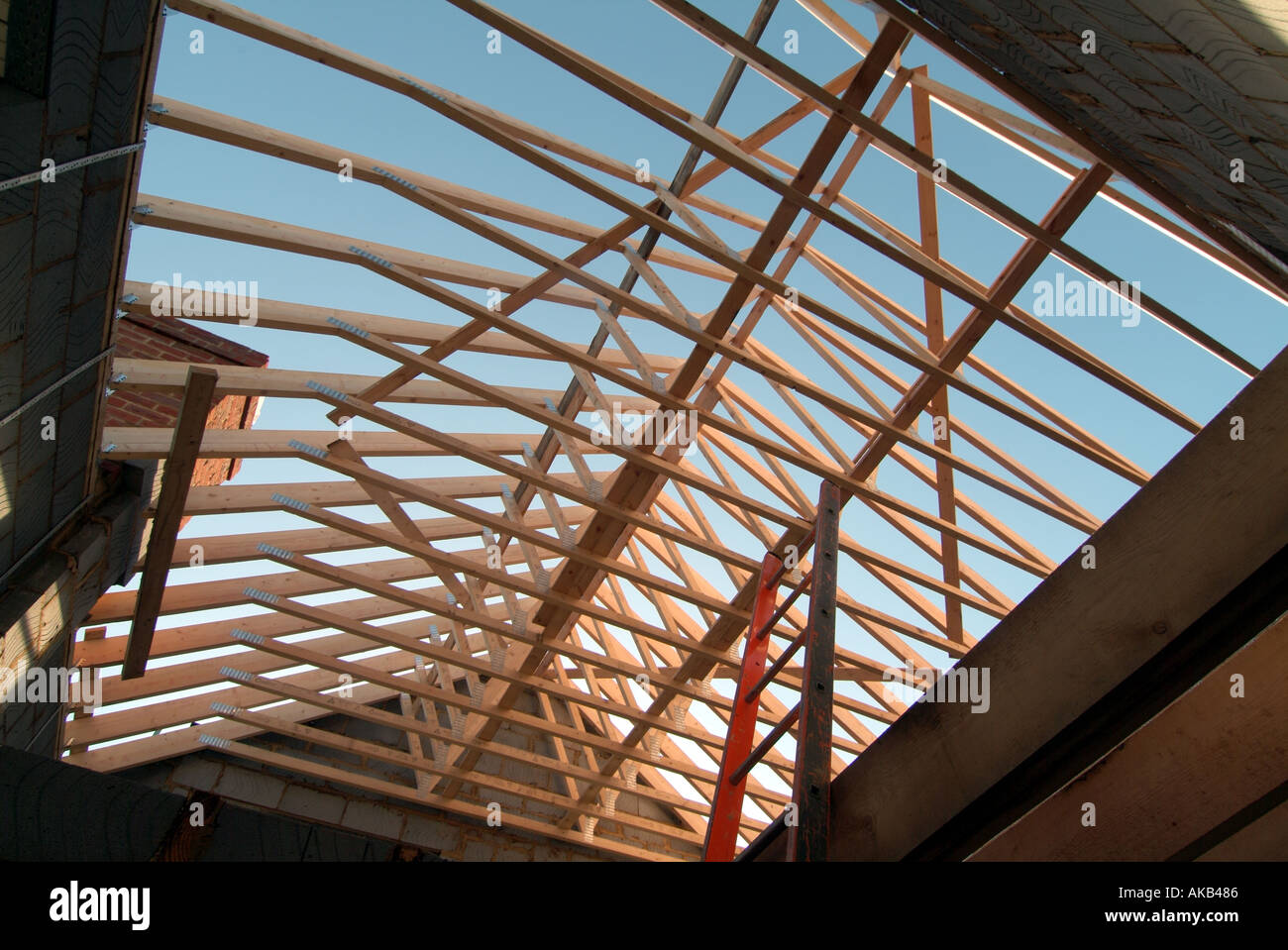 Skywards view of roof trusses on new detached house showing diagonal ...