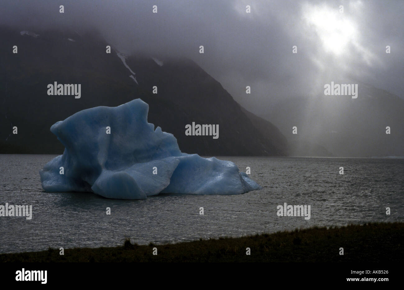 A polar ice cap is an icy sculpture beneath breaking grey clouds Stock ...