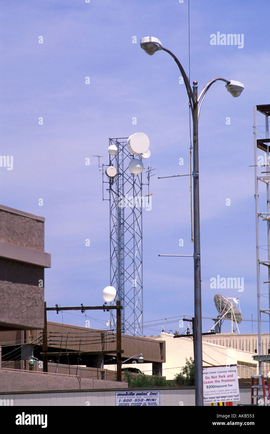 Radio and communications towers rise high above a brick parking garage ...