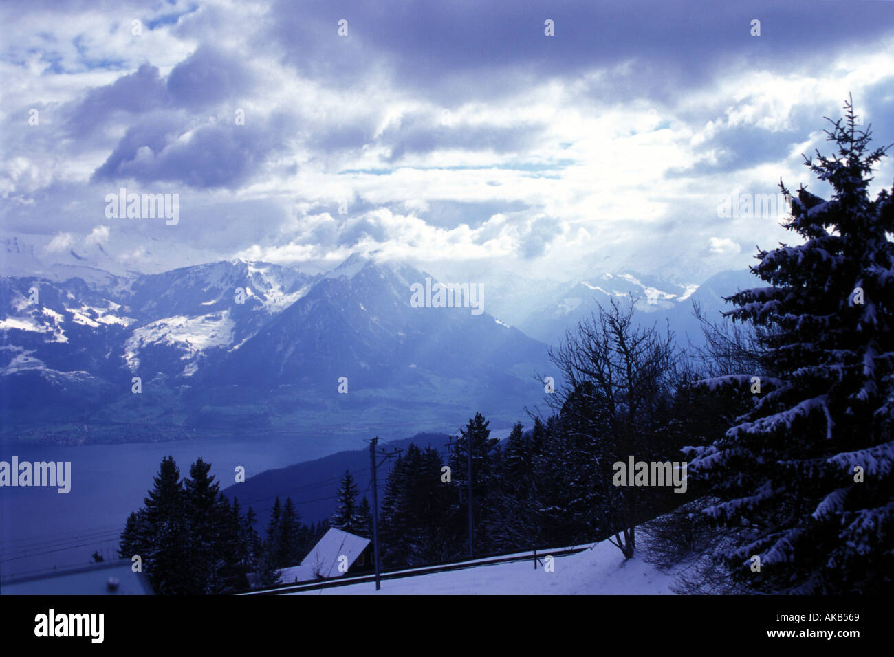 Massive snow peaked mounts form a magnificent backdrop to a quiet ...