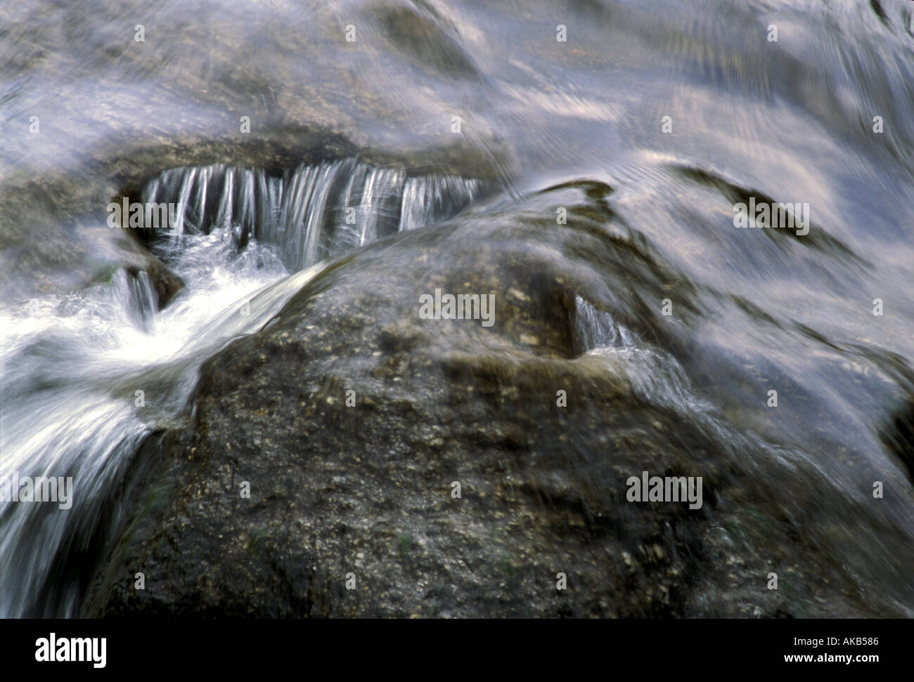 Fast water rushes across rock in gushing sheets and ever flowing ...