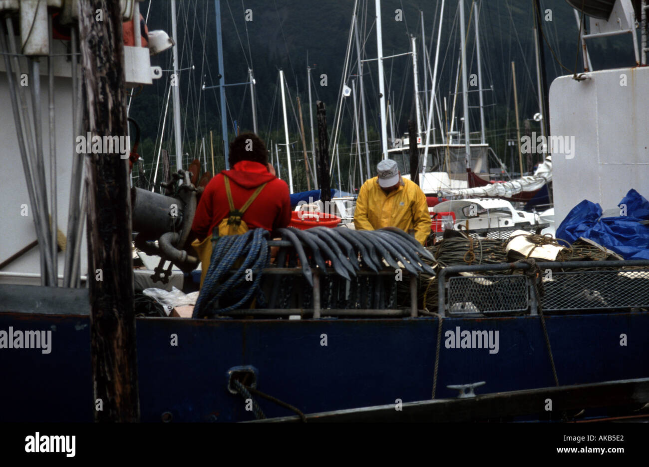 Two Halibut fishermen in Seward Alaska one wearing a harness another a ...