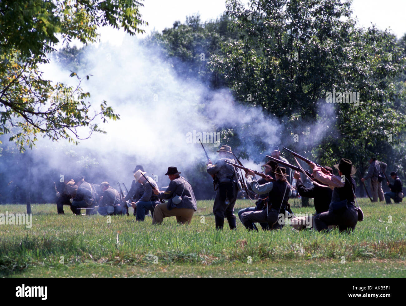 Foot soldiers line up on their knees loading and aiming muskets of the ...