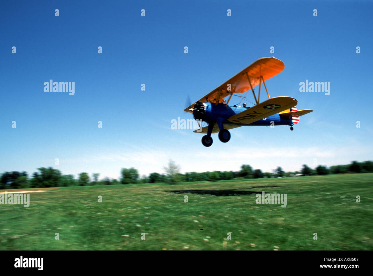 The bright colors of this biplane aircraft make it easy to see as it ...