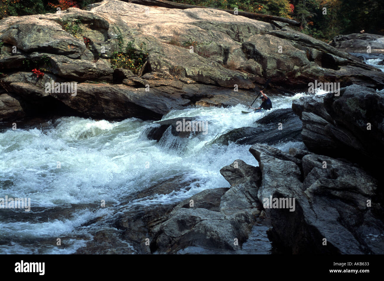 Sportsman guides kayak through powerful gushing river rapids as a ...