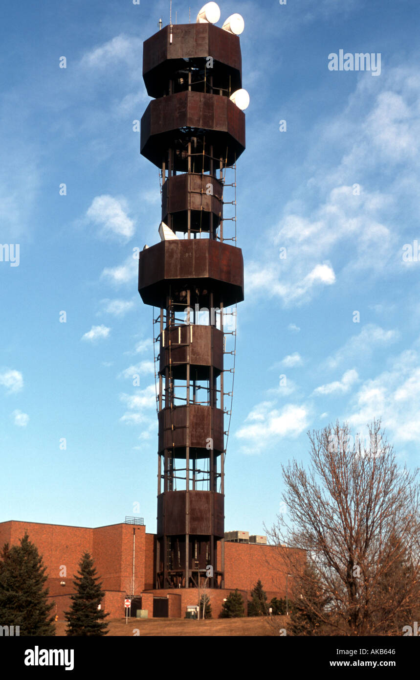 Round white satellite dishes sit above a brick corporate building and ...
