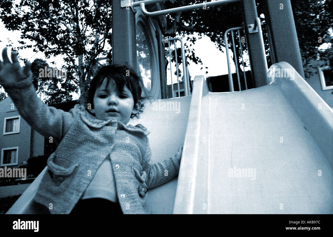Child going down slide blue tone Stock Photo - Alamy