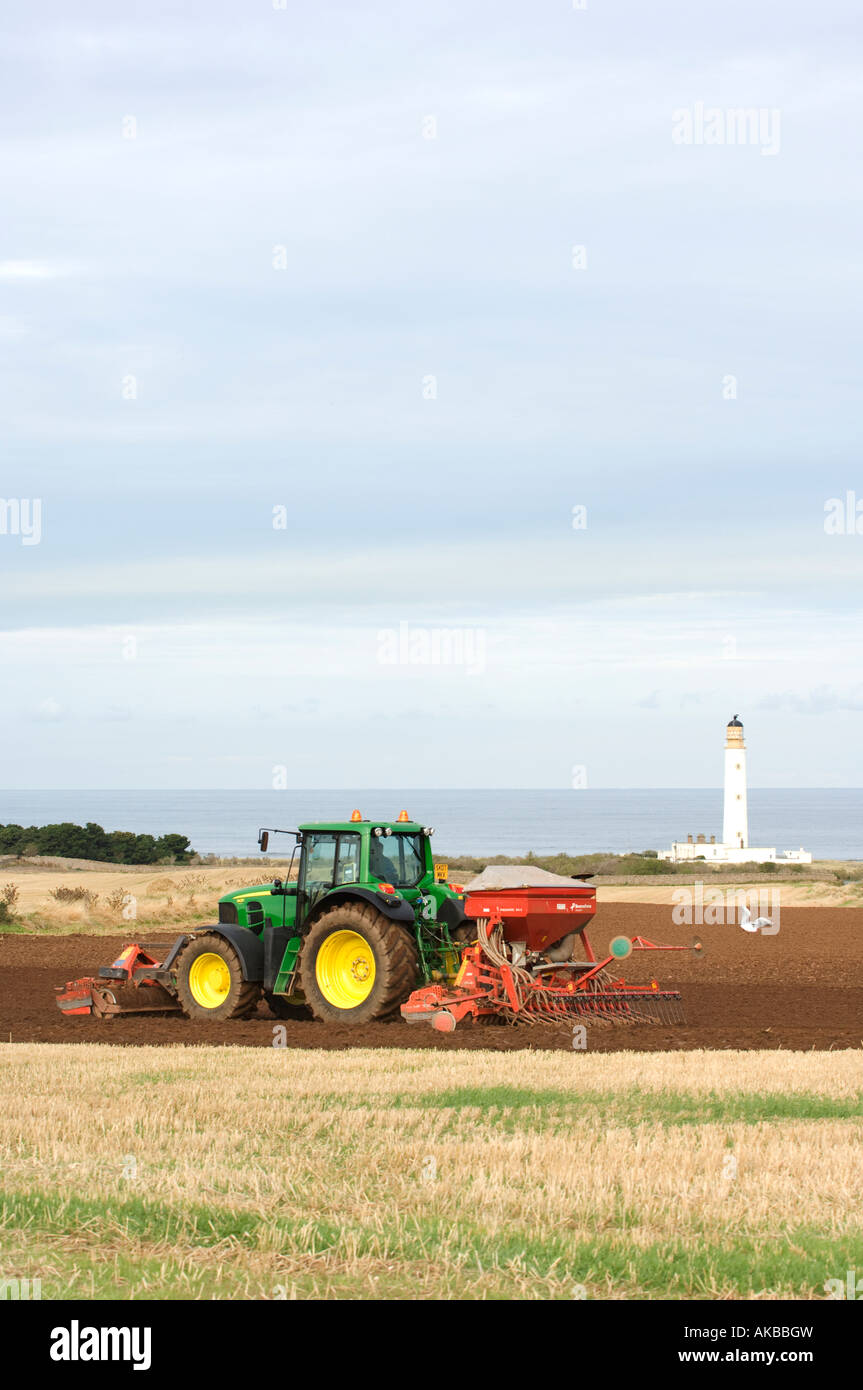 Tractor seeding field in Scotland Stock Photo - Alamy