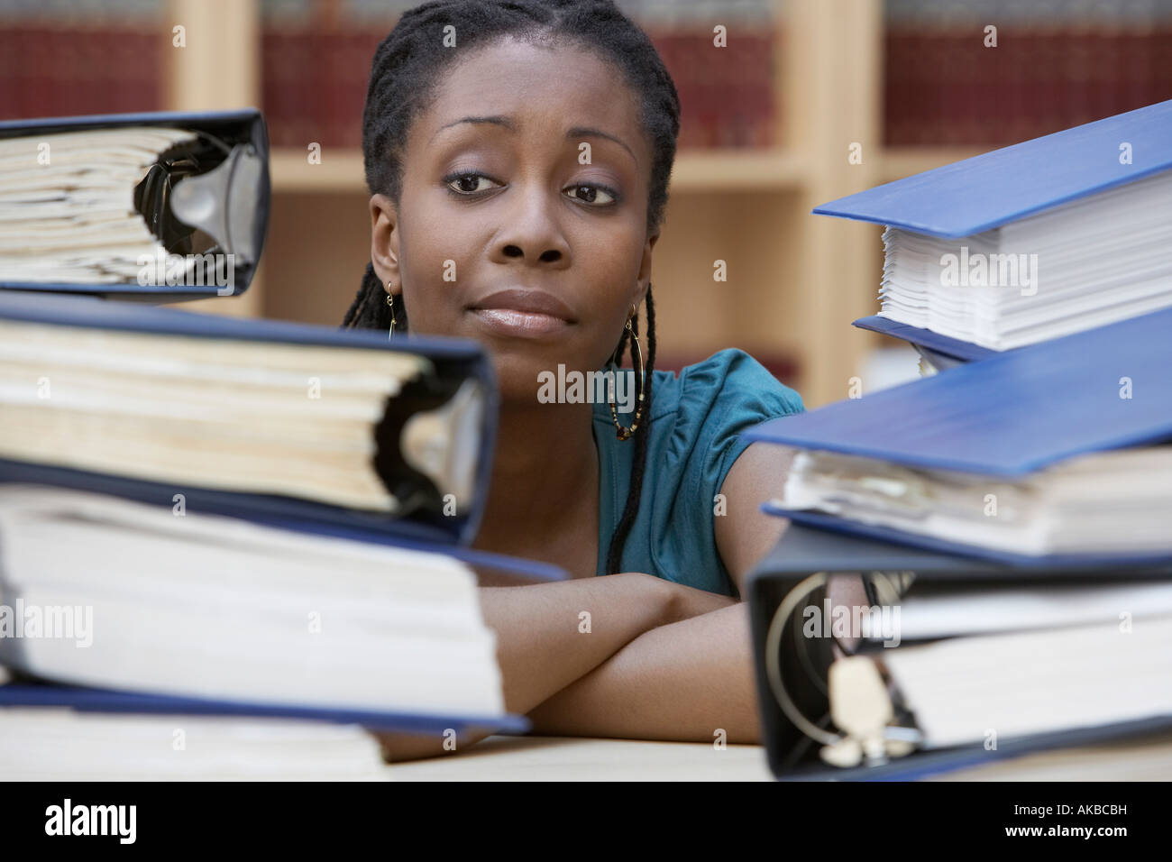Office worker sitting behind stacks of legal books in office Stock ...