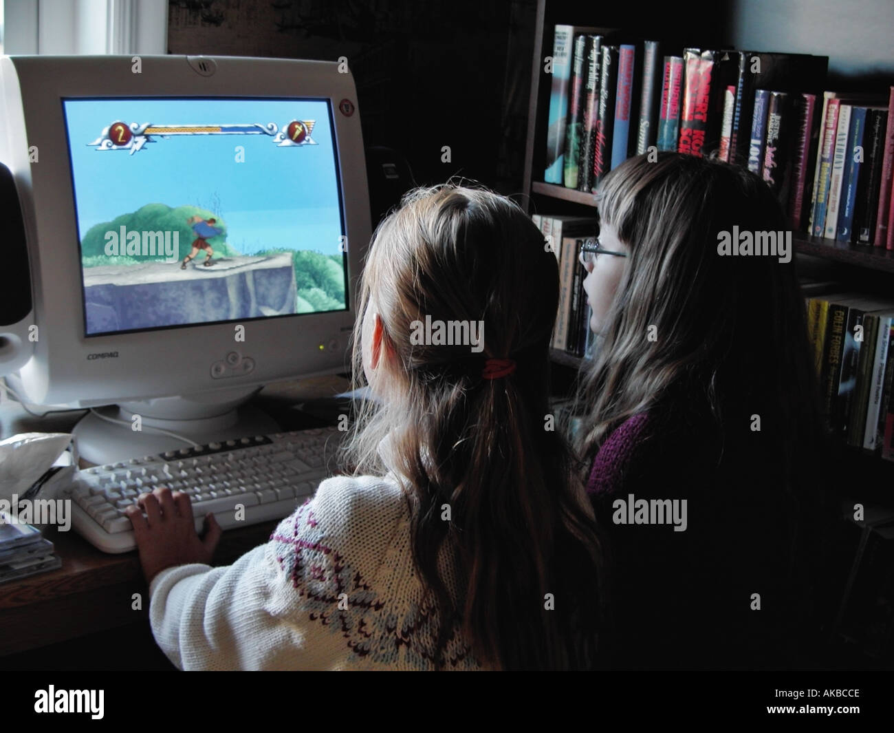 Two young girls playing a computergame Stock Photo - Alamy