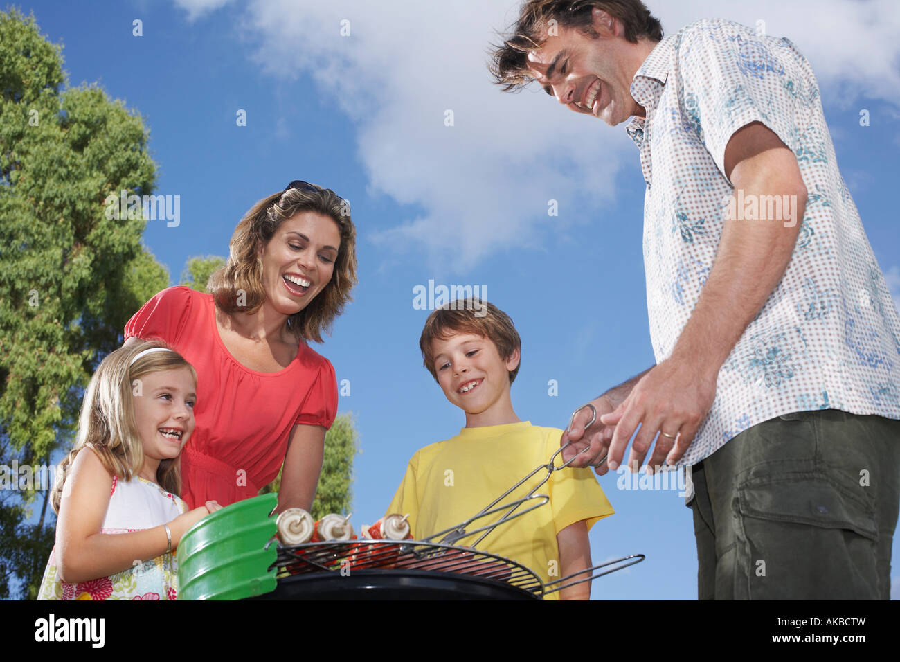 Family with two children (5-6) grilling in garden Stock Photo - Alamy
