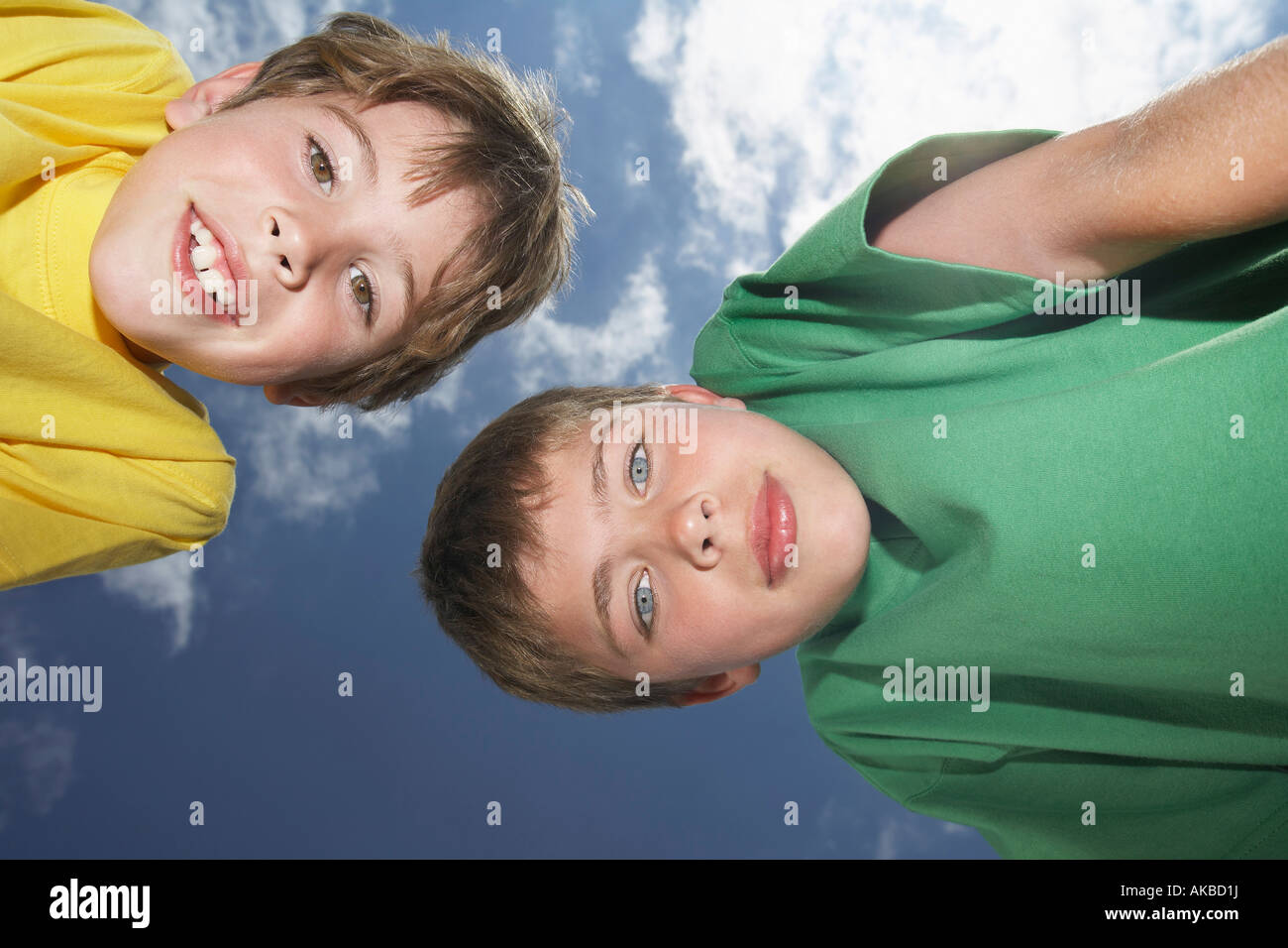 Portrait of two boys (6-11) bending down, view from below Stock Photo ...