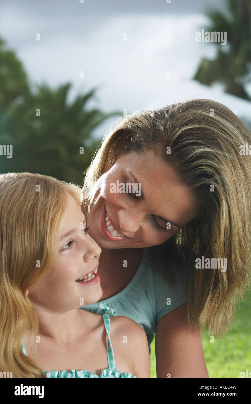 Mother and daughter (5-6) talking and laughing, outdoors Stock Photo ...