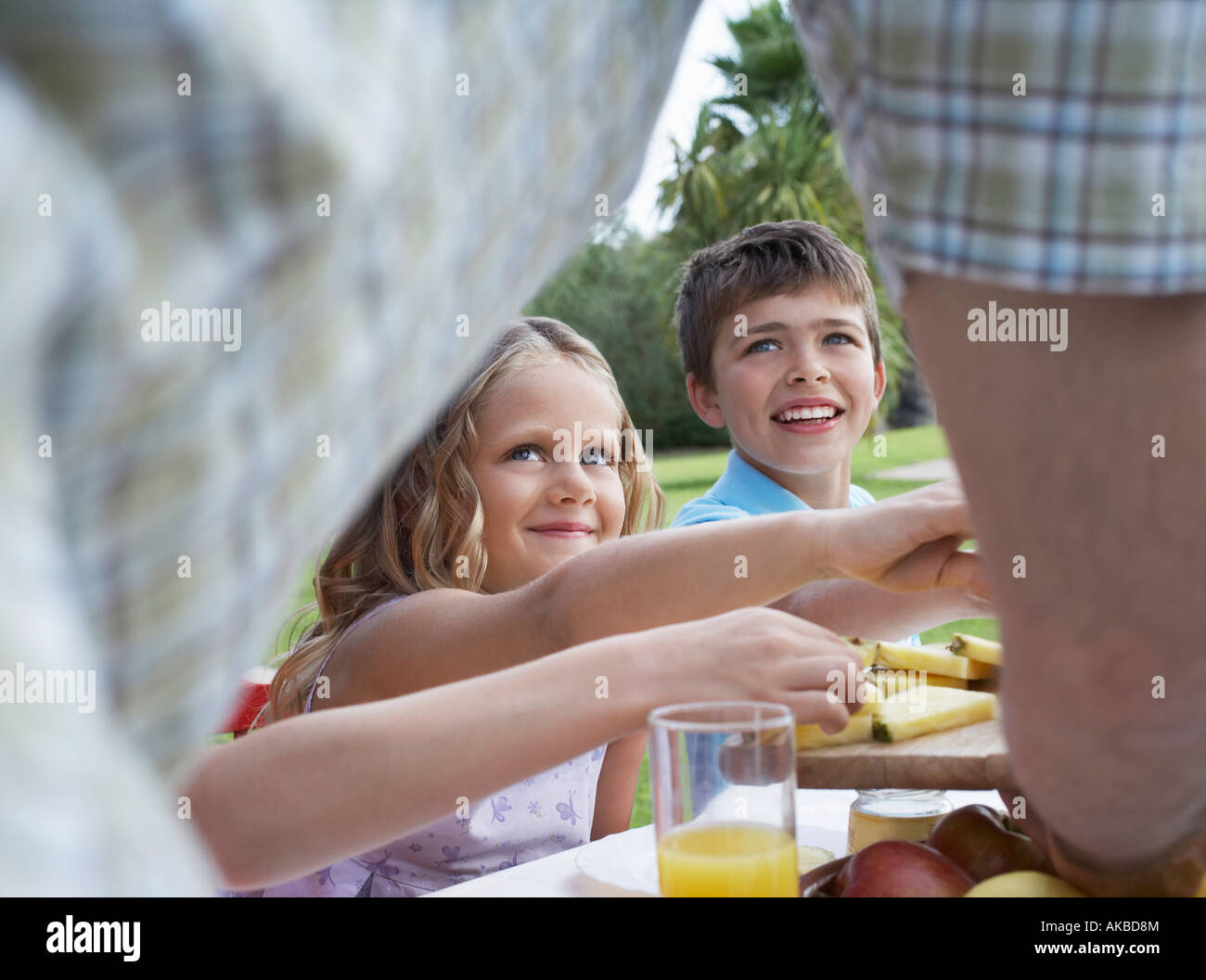 Small children sitting table outdoors hi-res stock photography and ...