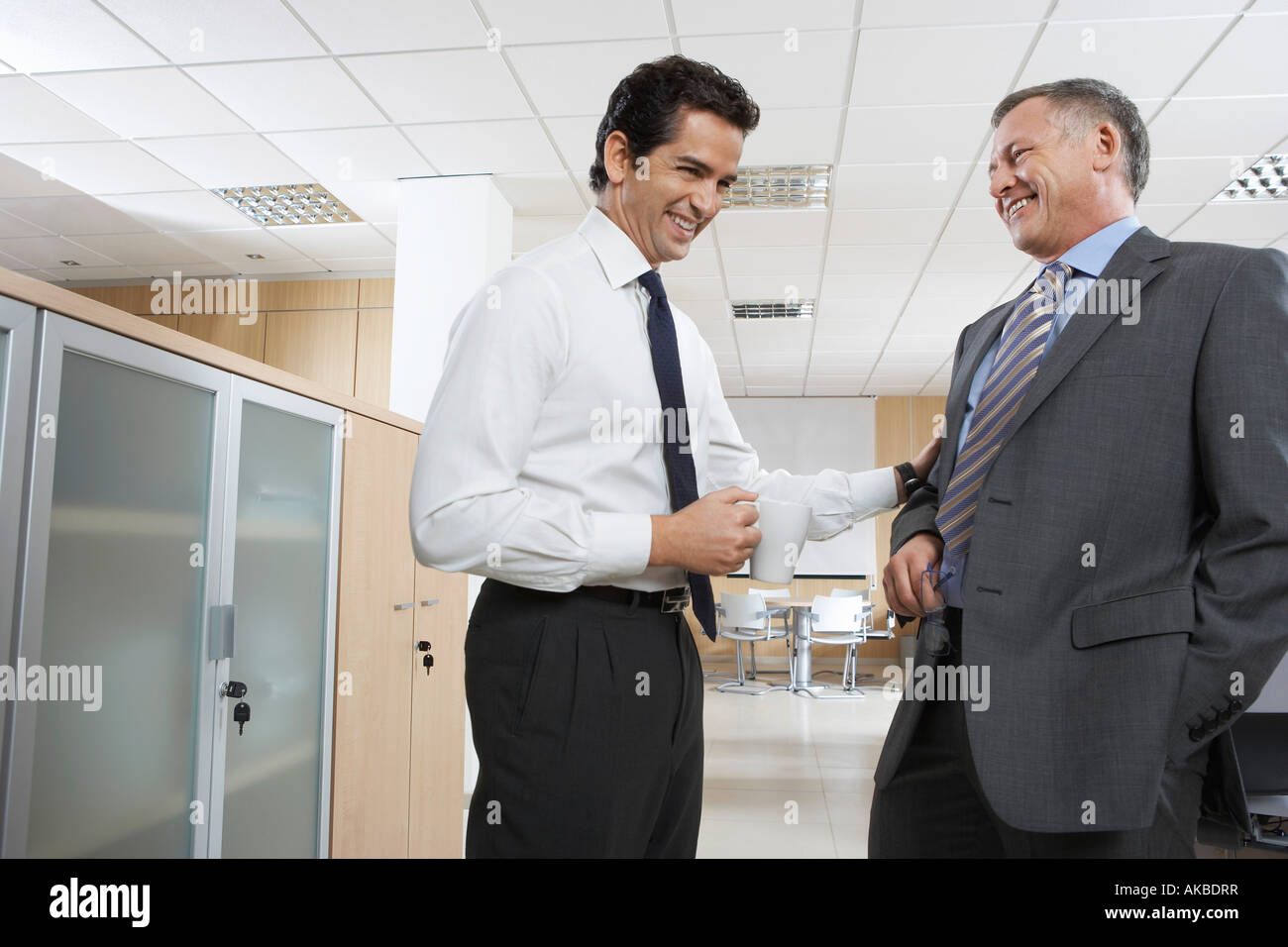 Two business men talking in office Stock Photo - Alamy