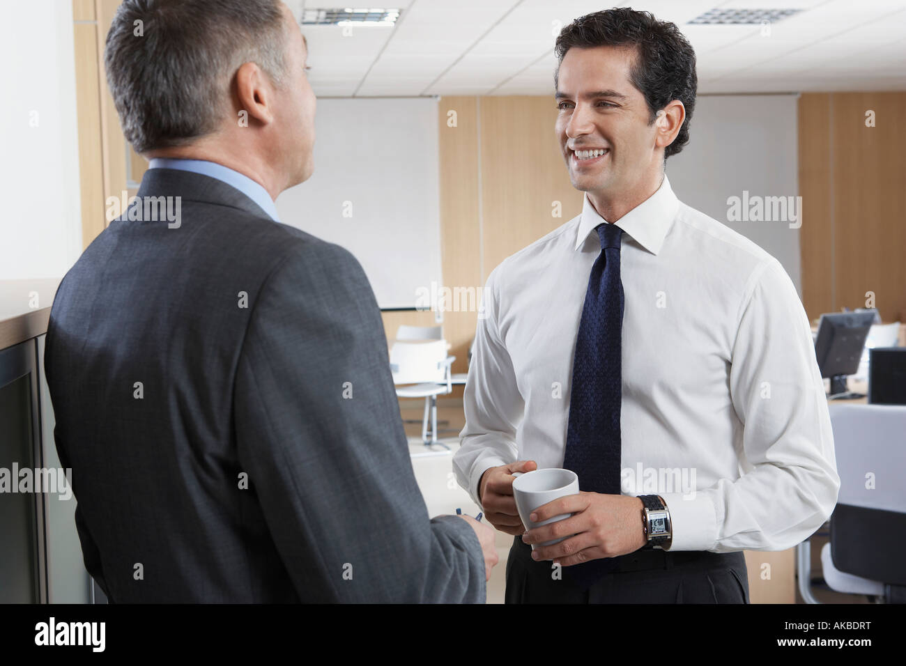 Two business men talking in office Stock Photo - Alamy