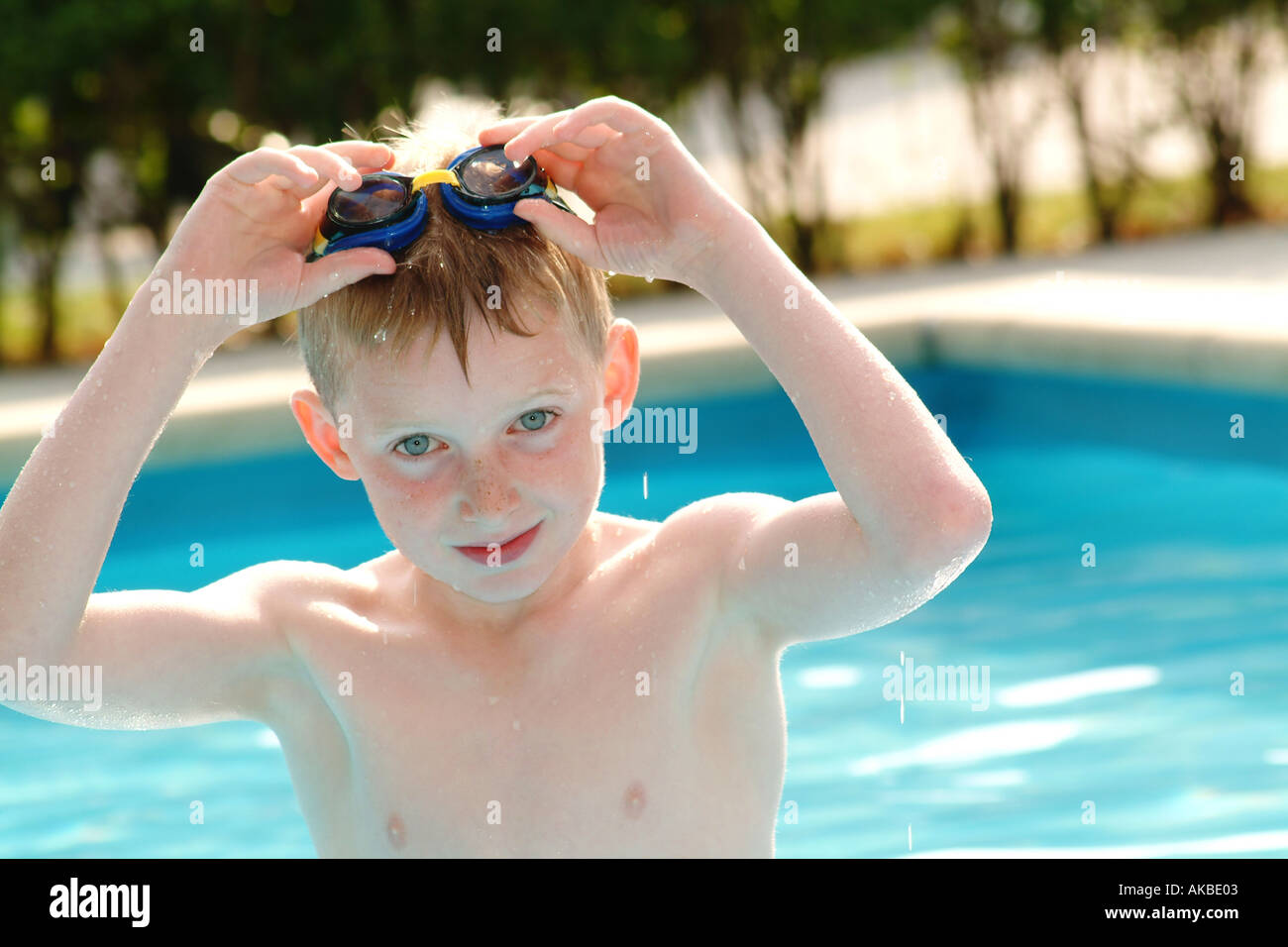 Boy playing in swimming pool Stock Photo - Alamy