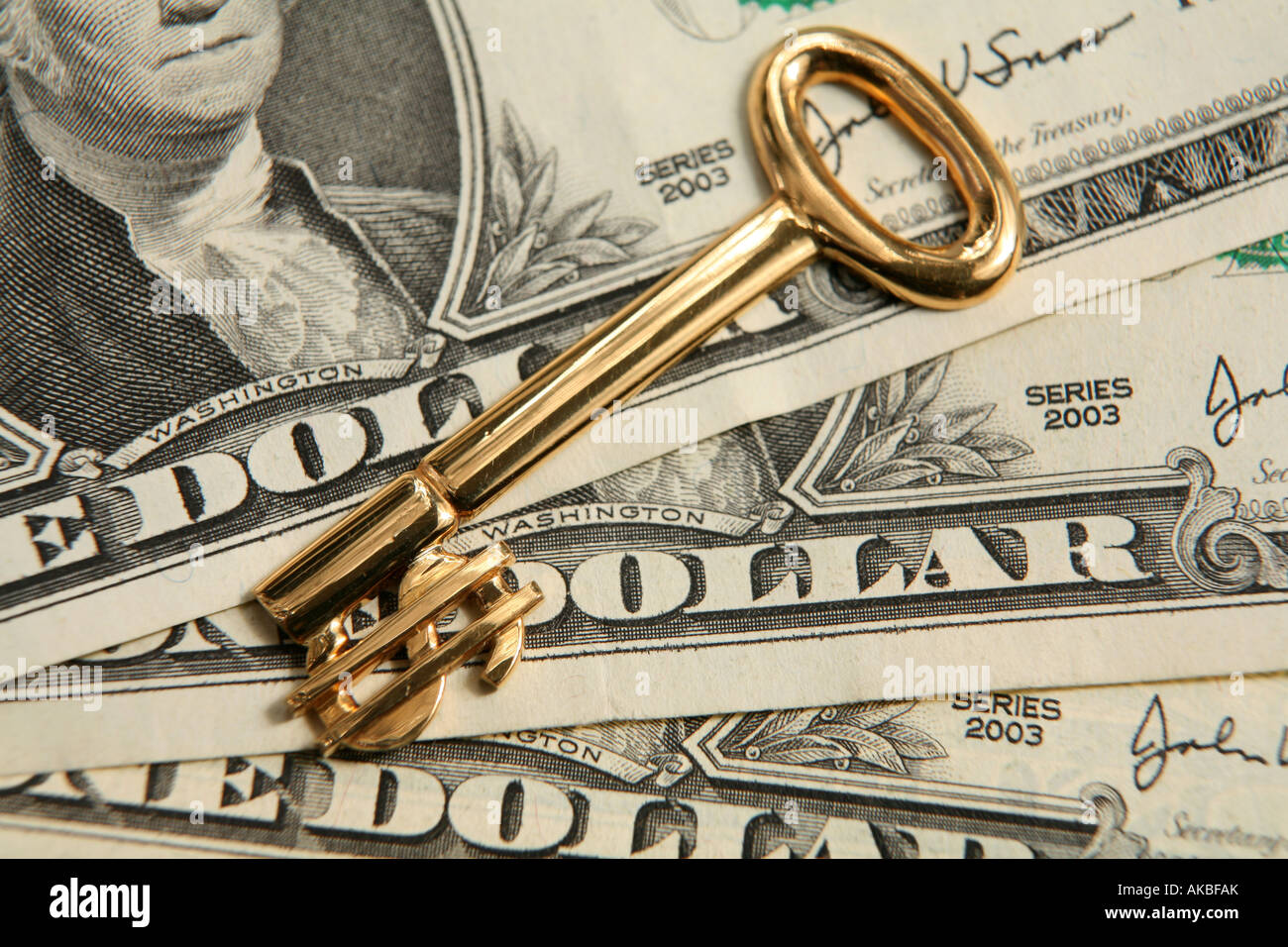 US currency notes with a gold key its end in the shape of the dollar ...