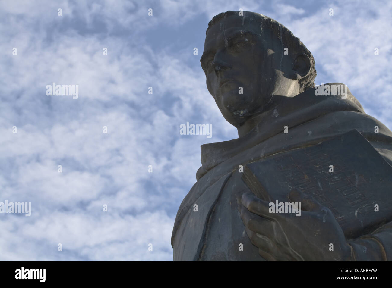 A friar statue with a book in his hands Stock Photo - Alamy