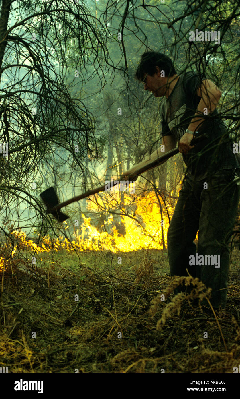 Fire fighter dealing with a Forest fire in the New Forest Hampshire ...