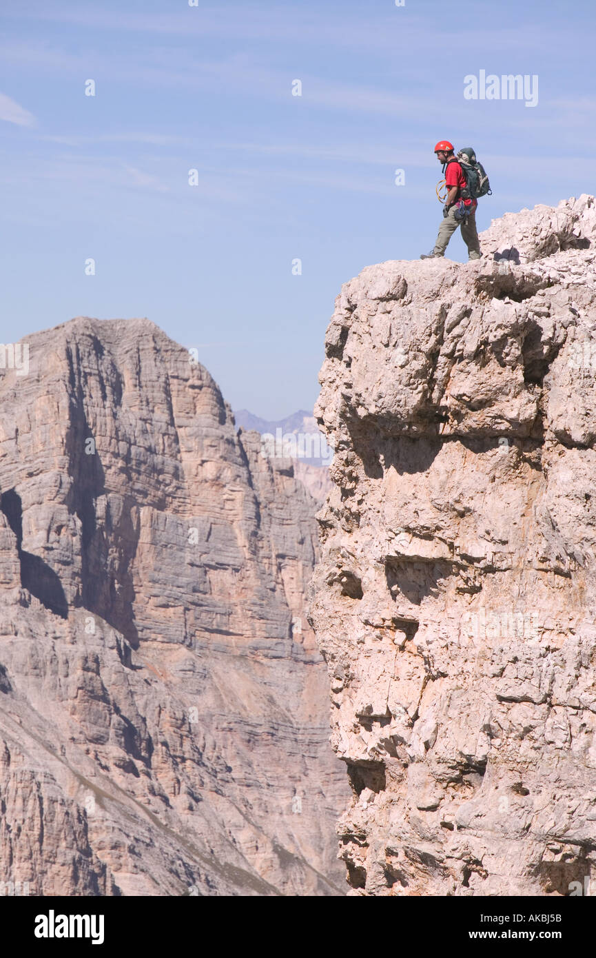 climber looking over an extremely exposed cliff section on the via ...