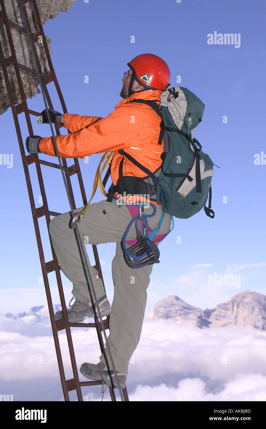 climber on a via ferrata route on a ladder on the Cristallo above the ...