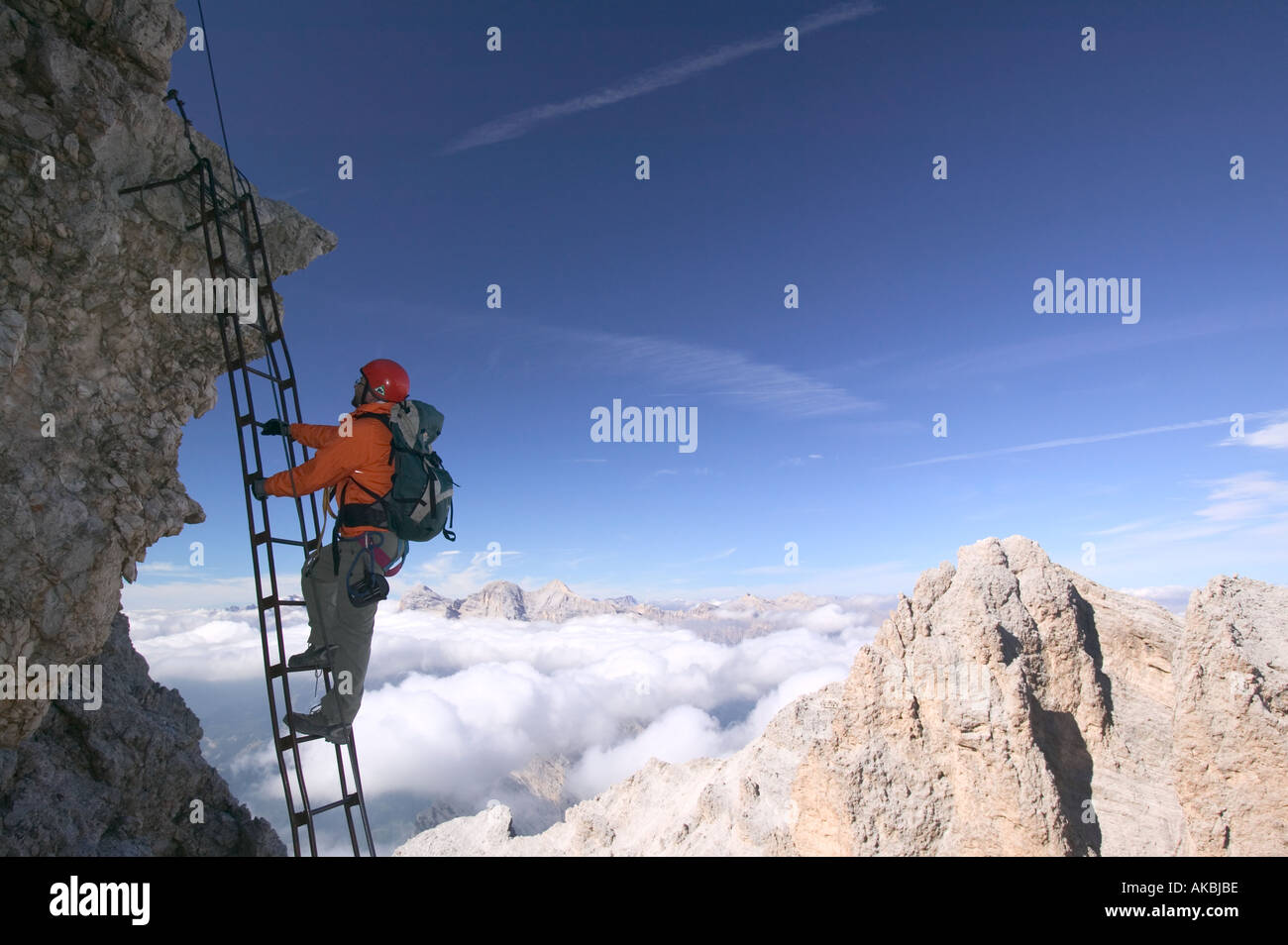 climber on a via ferrata route on a ladder on the Cristallo above the ...