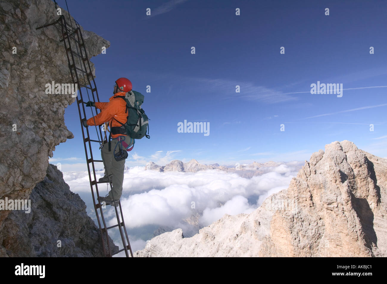climber on a via ferrata route on a ladder on the Cristallo above the ...