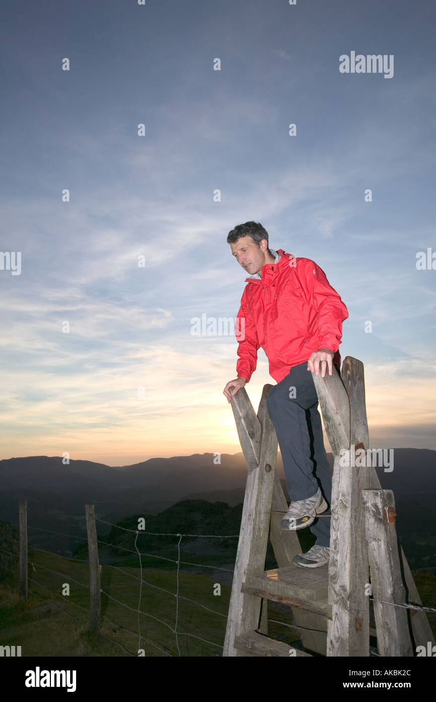 Man climbing over fence hi-res stock photography and images - Alamy