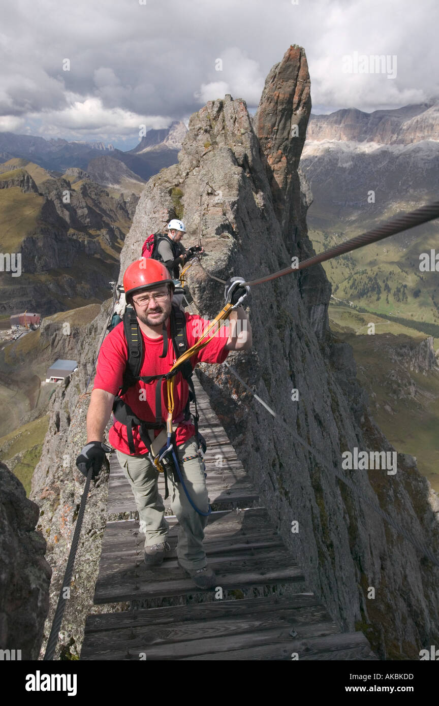 Climber on the Via ferrata Delle Trincee crossing a bridge Italian ...