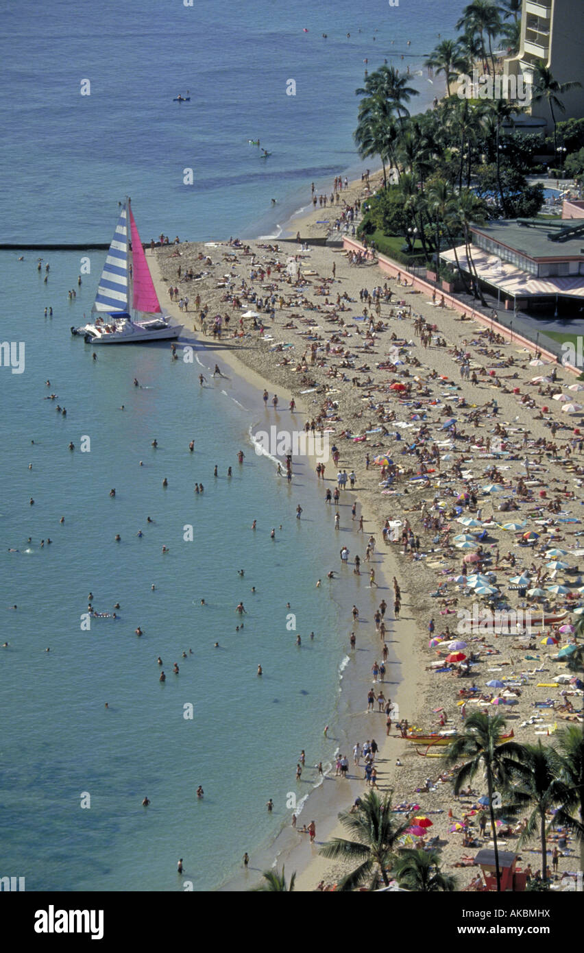A sailboat on a very crowded Waikiki Beach near Honolulu Stock Photo ...