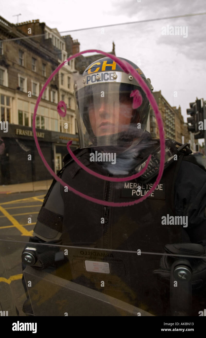Riot policeman behind his shield painted with a pink smiley face during ...