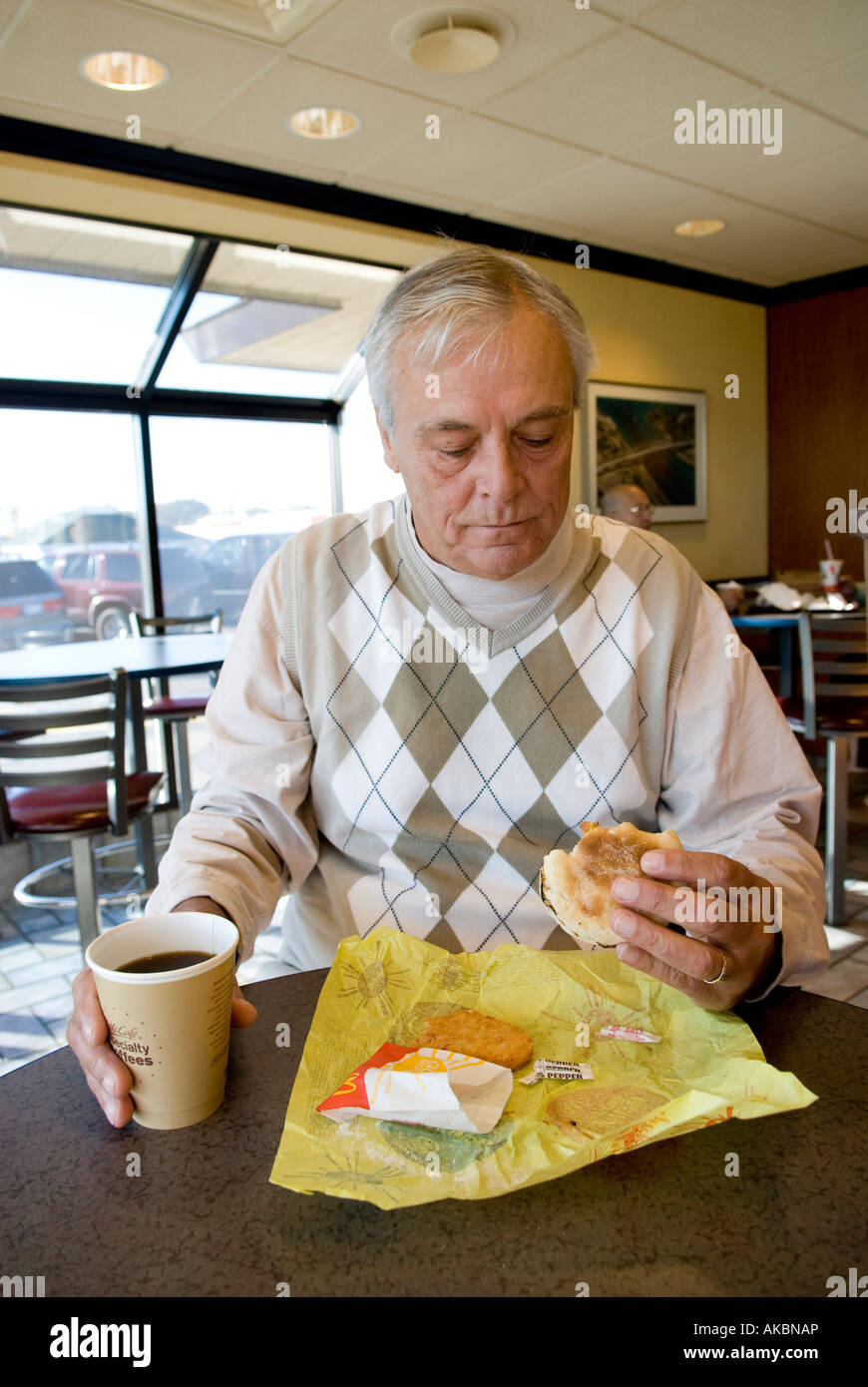 Adult male eating breakfast at a fast food restaurant Stock Photo - Alamy