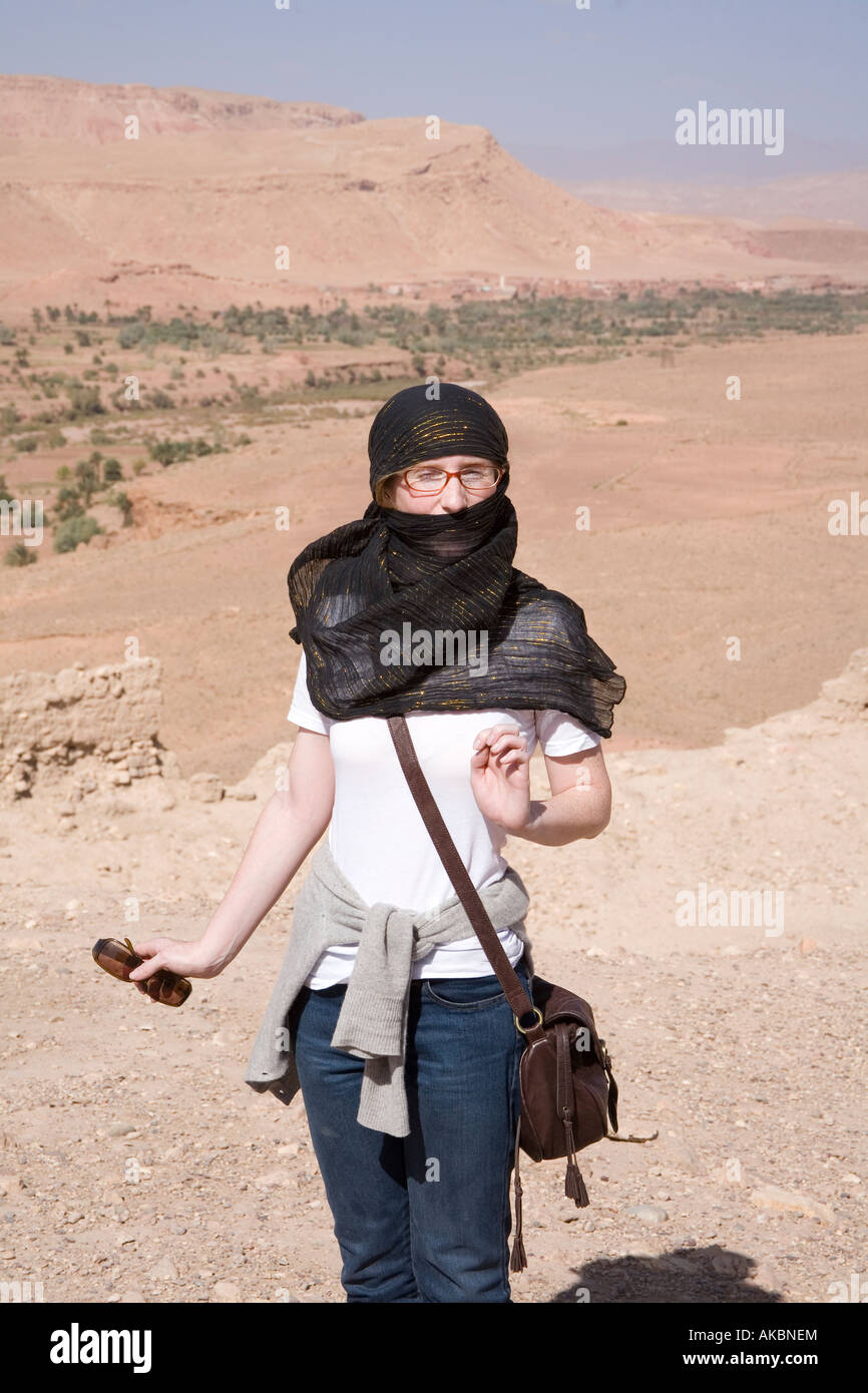 Young woman tourist dressed in a traditional Moroccan headscarf. Ait ...