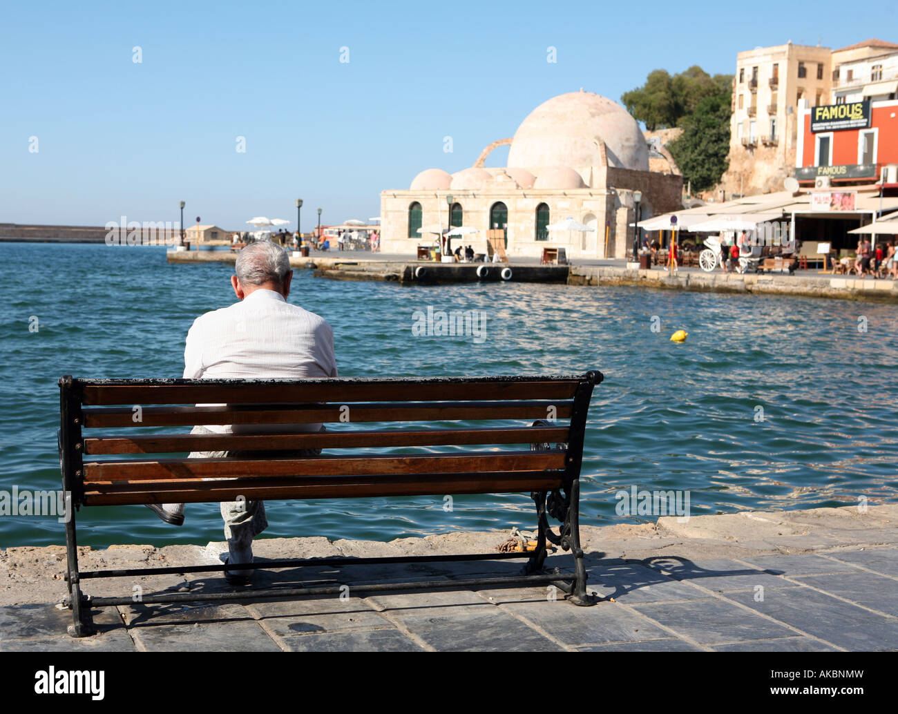 An elderly man enjoys the view at Hania harbour Crete Greece Stock ...