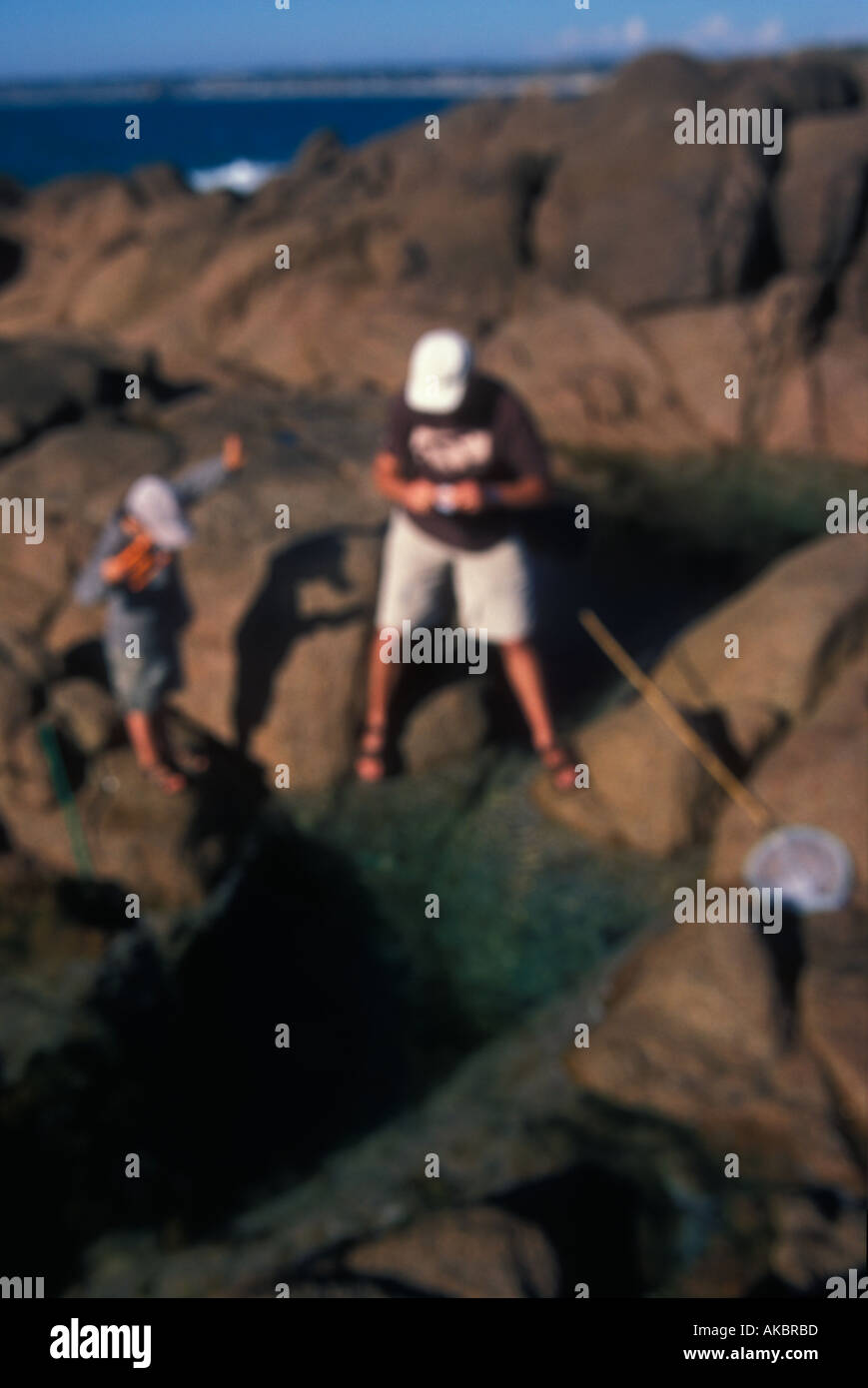 Father and Son Fishing in Rock Pools around Corbiere Lighthouse Stock Photo - Alamy