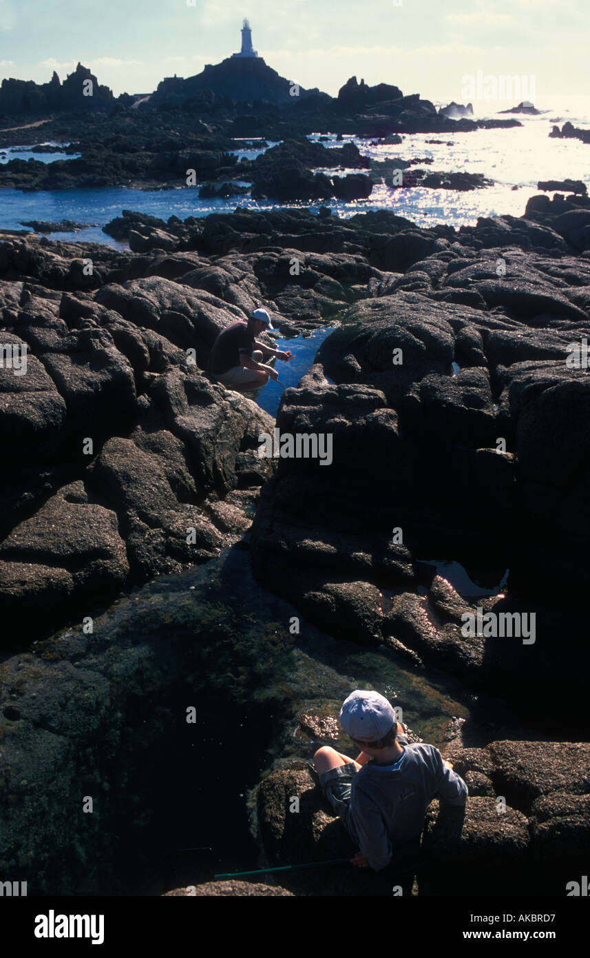 Young boy exploring rock pools in Jersey, Channel Islands Stock Photo ...