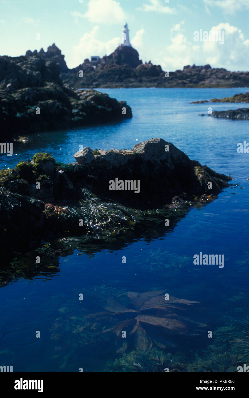 Rock pool in front of Corbiere Lighthouse Jersey Channel Islands Stock Photo - Alamy
